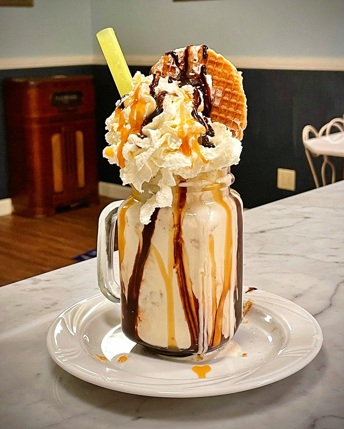 Not so much a milkshake as an architectural achievement &ndash; chocolate, caramel, and a waffle garnish creating a tower of dairy decadence.