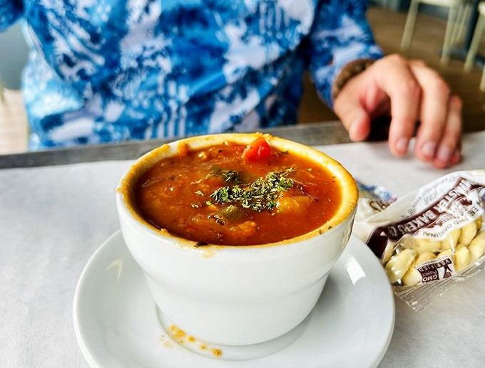 This Manhattan clam chowder isn't just soup—it's a tomato-based negotiation between New York attitude and Florida seafood that somehow works perfectly.