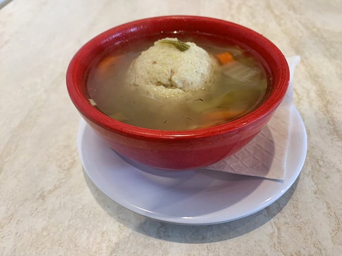 A matzo ball that floats like a cloud in golden broth. Grandmothers everywhere are nodding in approval at this bowl of liquid comfort.