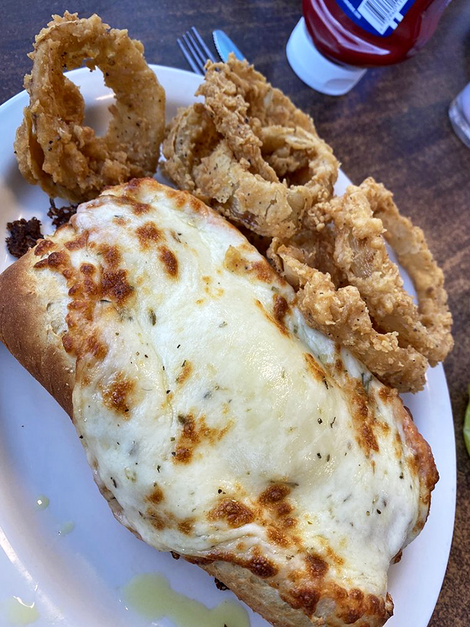 Melted cheese cascading over perfectly fried onion rings &ndash; a combination that makes you question why you'd ever need fancy dining again.