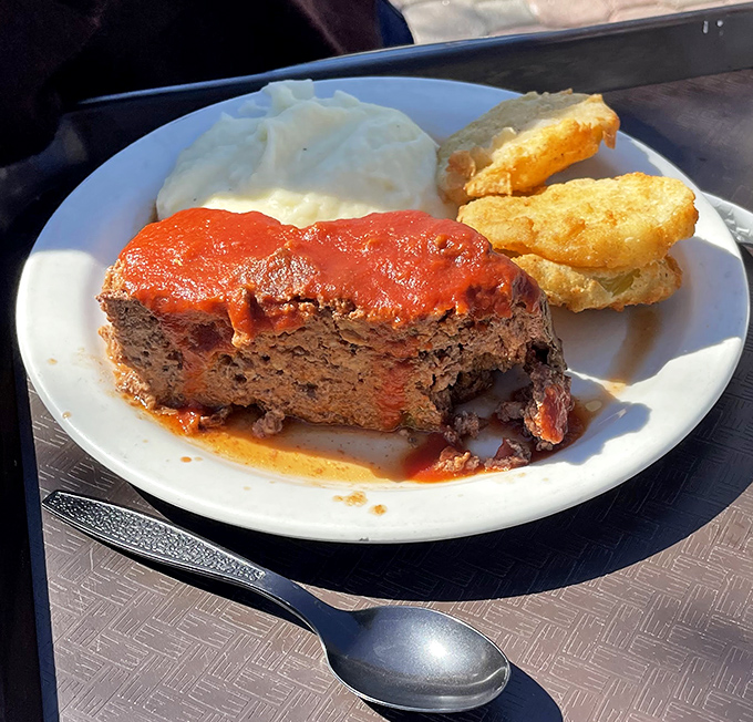 Meatloaf that would make your mama jealous, paired with cloud-like mashed potatoes. This isn't dinner&mdash;it's edible nostalgia on a plate.