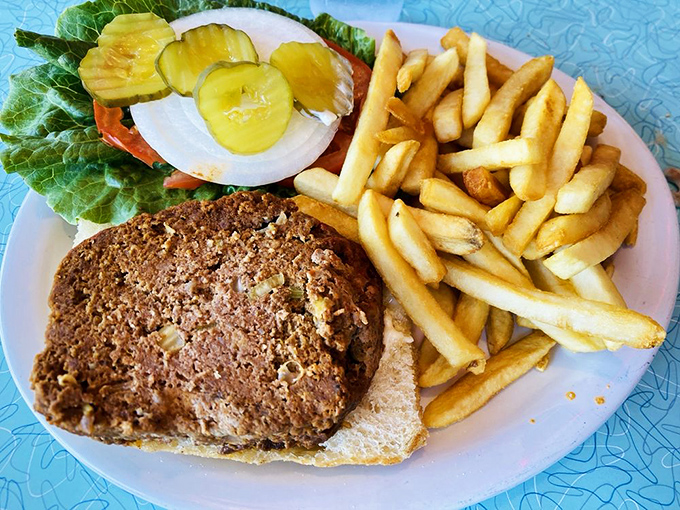 This isn't just a meatloaf sandwich; it's a time machine on a plate, complete with crispy fries and nostalgia served on the side.