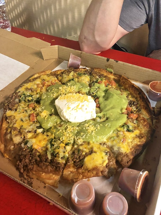 What happens when a pizza and enchilada have a beautiful baby? This masterpiece of melted cheese, green sauce, and savory meat.