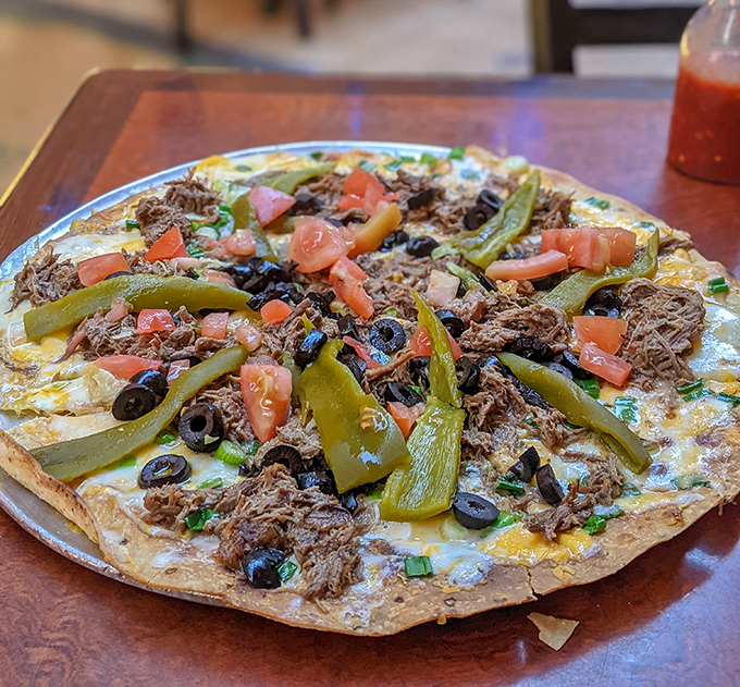 The Mexican Pizza arrives like a fiesta on a plate. Those green chiles and shredded beef are having the time of their lives together.