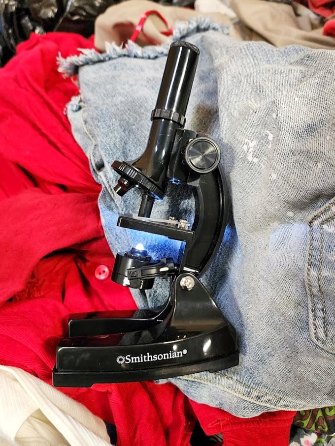 Science meets serendipity! A Smithsonian microscope nestled among clothing proves you never know what academic treasures await.
