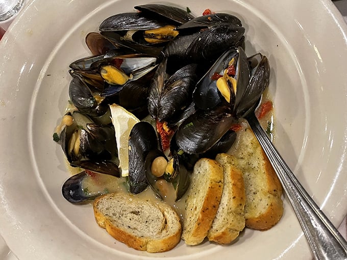 These mussels aren't just opened, they're having a full-blown conversation with that grilled bread, telling tales of white wine, garlic, and the sea.