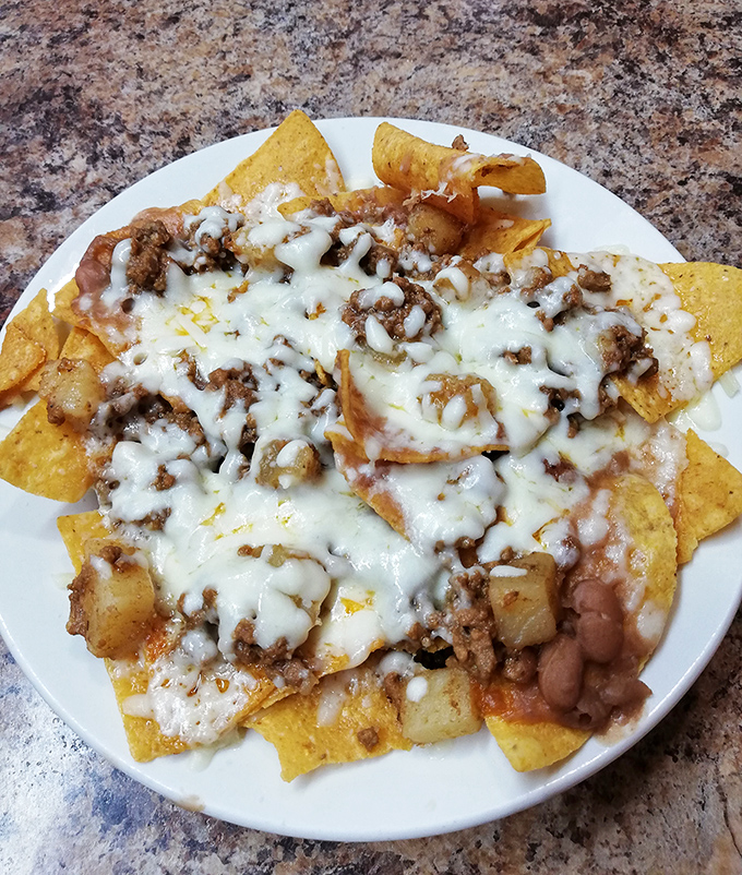 Nachos that don't mess around – loaded with melted cheese, seasoned beef, and beans. The kind that disappear faster than you planned.