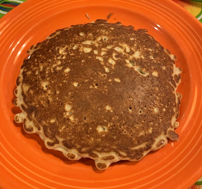 Golden-brown perfection on an orange plate&mdash;this pancake has achieved what many politicians can't: being both substantial and light simultaneously.