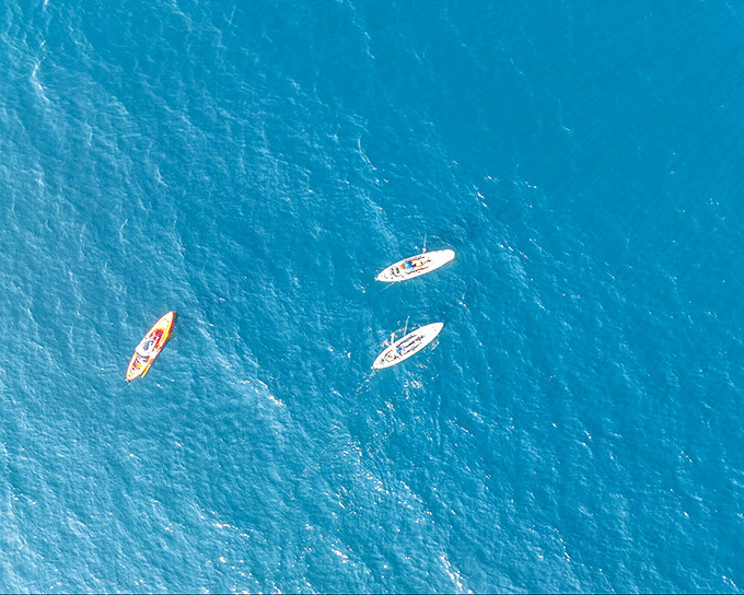 Who needs expensive entertainment when you can paddle into the blue beyond? These kayakers found adventure for the price of a rental fee.
