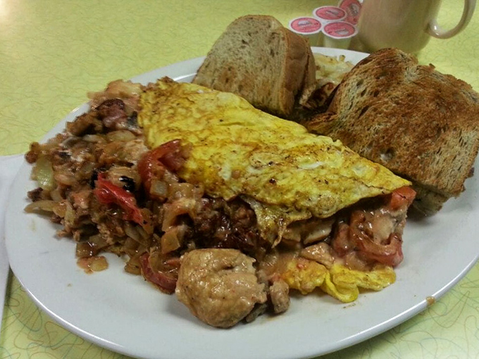 This loaded omelette arrives like a savory sunrise, accompanied by those legendary crispy potatoes.