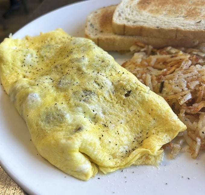 This omelet doesn't need to show off&mdash;it knows exactly what it is: fluffy eggs embracing melted cheese with perfectly crisped hash browns standing guard.