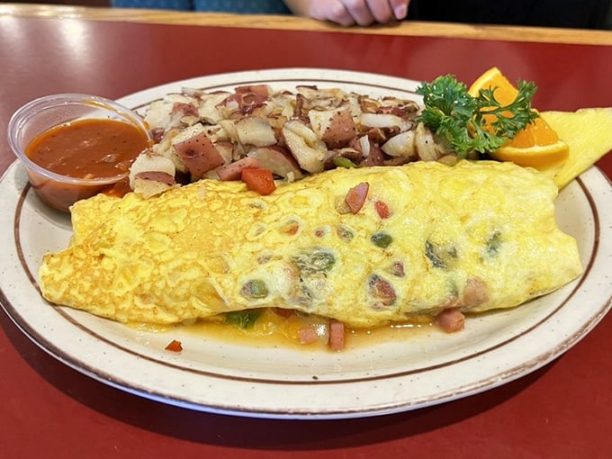 This isn't just an omelet&mdash;it's a masterpiece of morning engineering with perfectly distributed fillings and hashbrowns that demand attention.