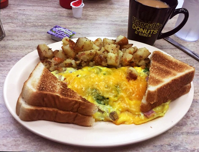 Behold the Western omelet in its natural habitat&mdash;fluffy, generous, and surrounded by perfectly seasoned home fries. Breakfast doesn't get more honest than this.