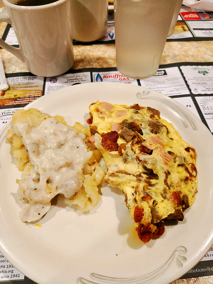 Breakfast perfection on a plate&mdash;a hearty omelet studded with ham and cheese alongside creamy hash browns that would make any morning person out of you.