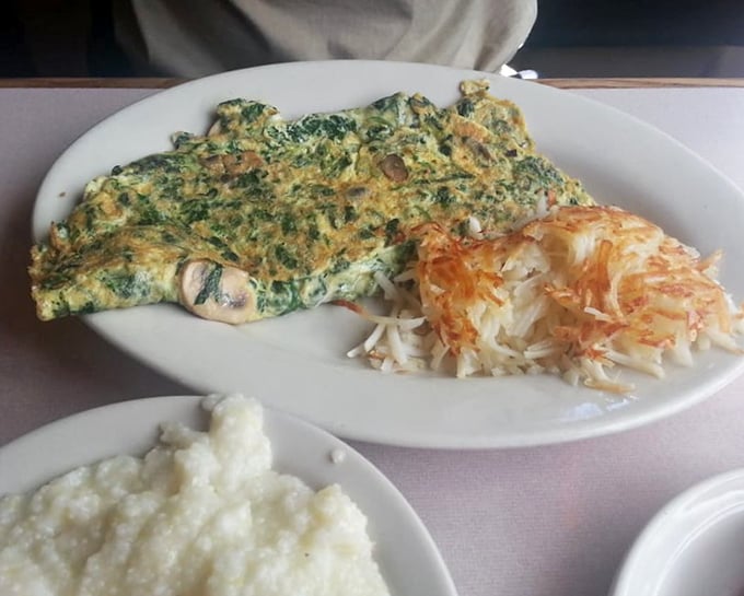 A garden omelet that's practically a vegetable patch wrapped in eggs, served with hash browns that achieve that perfect crisp-to-fluffy ratio.