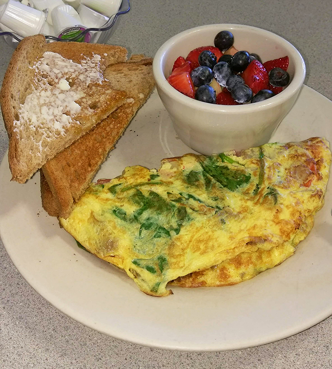 This isn't just an omelet; it's a masterclass in egg architecture&mdash;fluffy, vibrant with fresh herbs, and paired with toast and berries for the breakfast trifecta.
