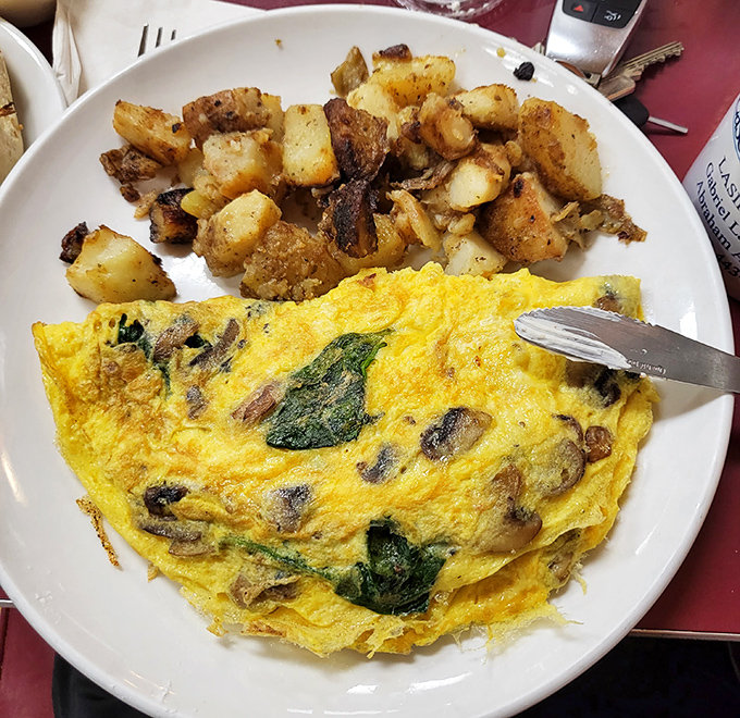 This isn't just an omelet&mdash;it's a fluffy yellow canvas painted with mushrooms and spinach. The home fries? Crispy little masterpieces.