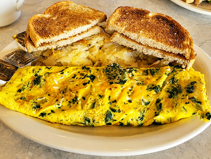 This spinach and cheese omelet doesn't just whisper "good morning"—it belts it out like Sinatra, with perfectly toasted bread as backup singers.