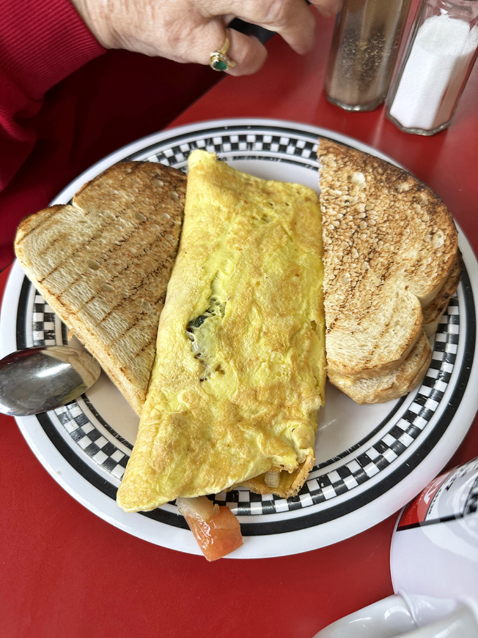 This fluffy omelet with perfectly toasted bread represents everything wonderful about traditional American breakfast craftsmanship.