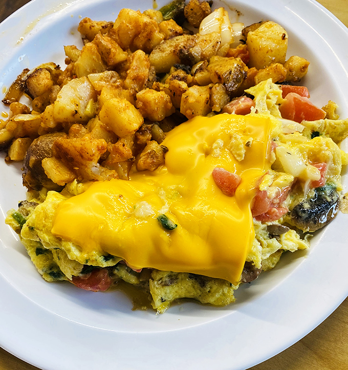This isn't just an omelet - it's a fluffy yellow canvas topped with chili that transforms breakfast into pure art.