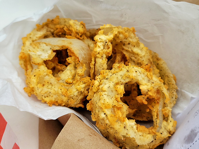 These aren't just onion rings; they're golden halos of crispy perfection. The kind that make you forget your table manners as you reach for "just one more."