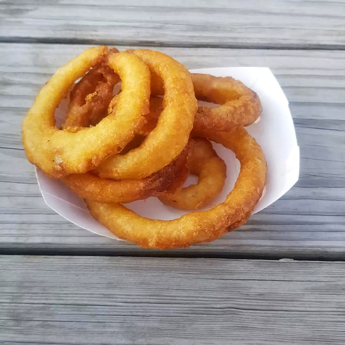 Golden halos of deep-fried perfection. These onion rings achieve that mythical balance &ndash; crispy exterior giving way to sweet, tender onion within.