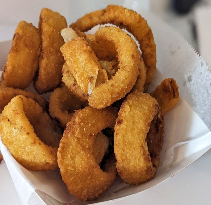 Golden, crispy onion rings that shatter with each bite. The perfect sidekick to the main event, like Robin to Batman.