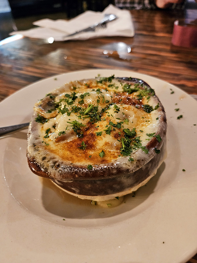 This isn't just French onion soup&mdash;it's a cheese-capped miracle in a crock, waiting for you to break through to the caramelized treasure below.