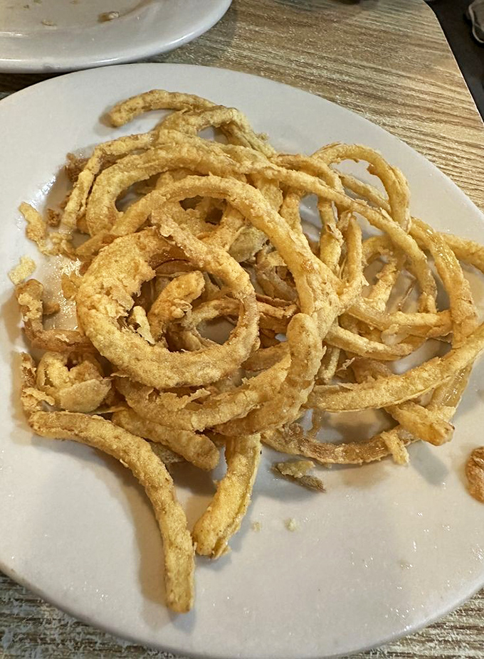 These onion rings aren't just side dishes &ndash; they're golden halos of crispiness that deserve their own fan club and commemorative t-shirt.