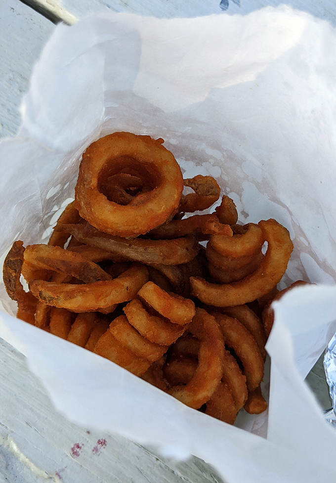 These aren't just onion rings; they're golden halos of crispy perfection that make you question why you ever wasted time on lesser versions.