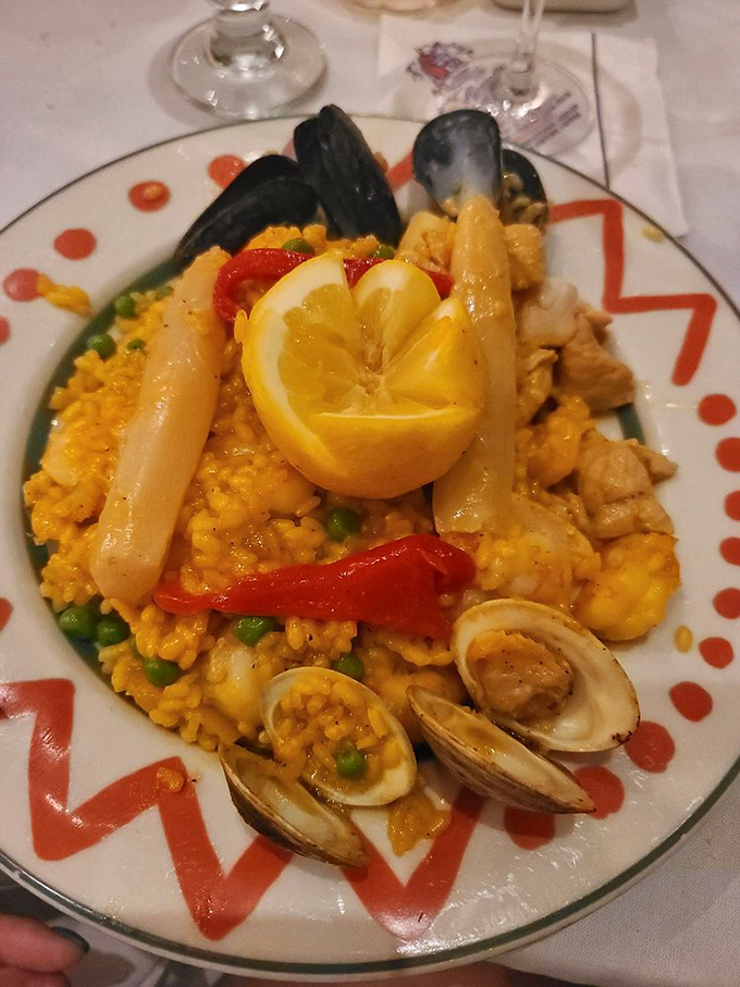 Paella Valenciana arrives like a saffron-hued celebration on a plate&mdash;seafood, chicken and vegetables creating a Spanish symphony that would make even paella purists swoon.