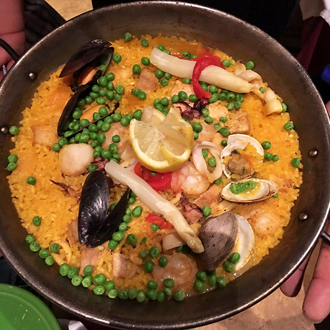 Paella Valenciana: where saffron-kissed rice meets seafood in a pan so hot it's practically doing the flamenco. Worth every minute of the 30-minute wait.