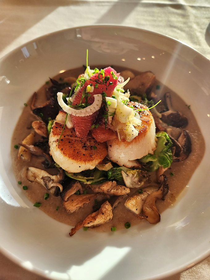 These scallops aren't just seared&mdash;they're transformed into buttery ocean jewels atop a bed of wild mushrooms and savory broth.