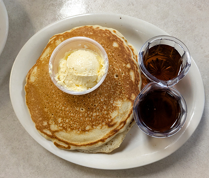 A pancake so perfectly golden it could win medals, topped with a scoop of butter and served with syrup&mdash;breakfast nirvana achieved.