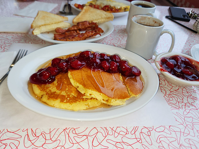 These golden pancakes topped with cherry compote might make you weep with joy. The maple syrup river waiting to happen is breakfast nirvana.