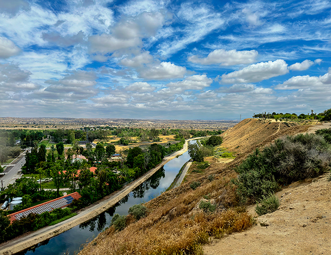 From Panorama Park's scenic overlook, Bakersfield unfurls below like a patchwork quilt of urban life, agriculture, and the canal that keeps it all flowing.