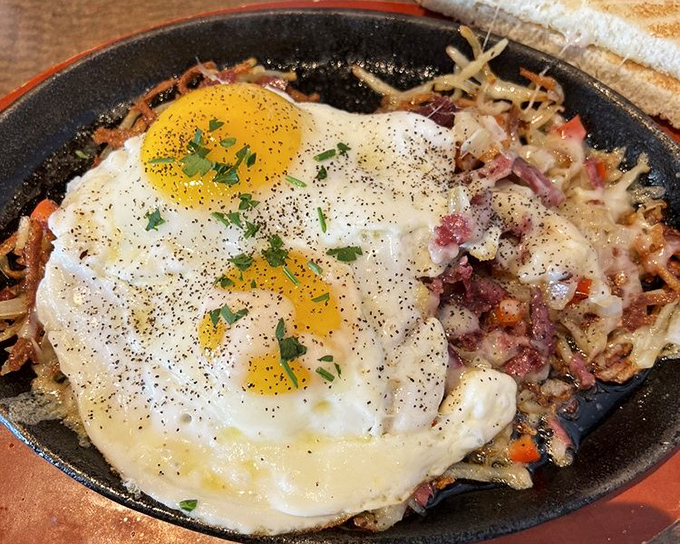 When hash browns, eggs, and pastrami unite in a cast-iron skillet, magic happens. That yolk is about to create a sauce worthy of worship.