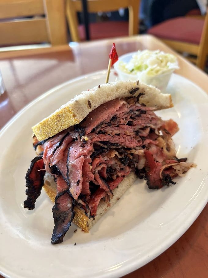 Pastrami so perfectly blackened at the edges it could make a New Yorker weep with joy, piled high between seeded rye.