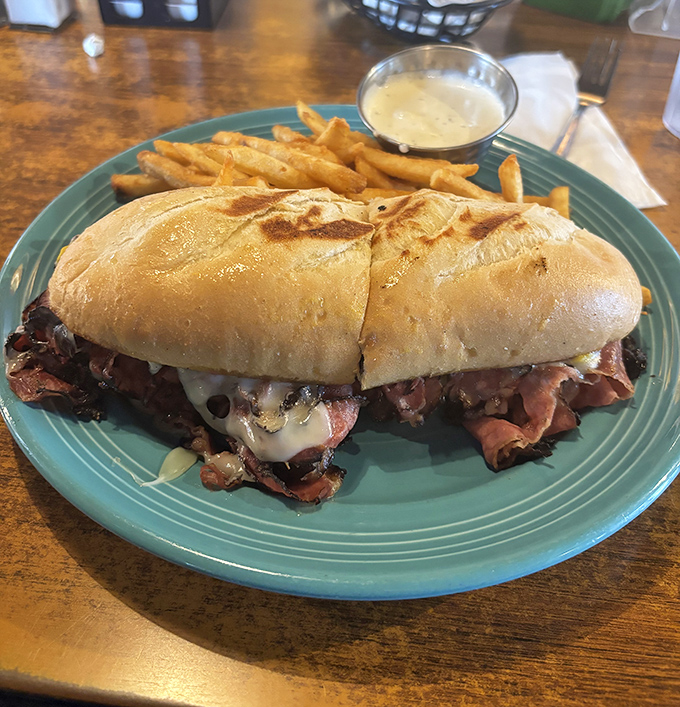 A sandwich that requires both hands and a strategy. This pastrami masterpiece makes you wonder why you'd ever settle for those skinny city versions.