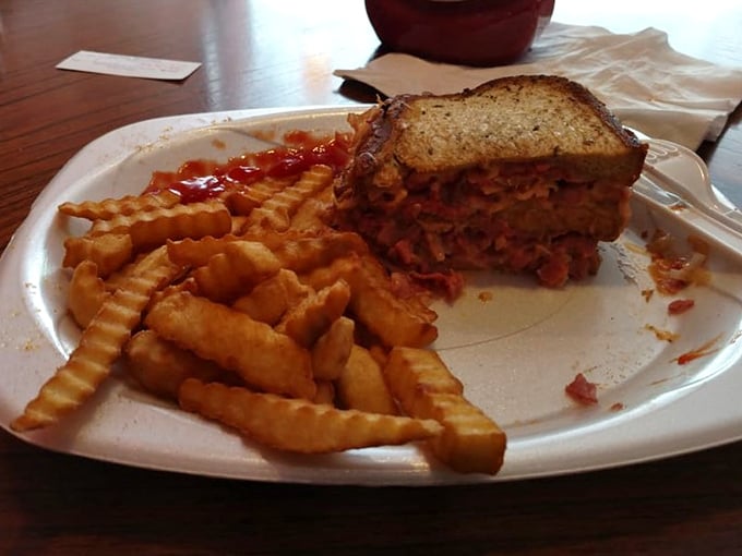 This isn't just a sandwich; it's an architectural marvel of meat and bread. The kind of pastrami stack that makes New Yorkers nervously question their superiority.