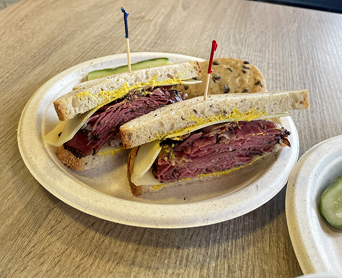 Pastrami piled so high between rye bread, it needs those toothpick flags to claim territory in this sandwich masterpiece.