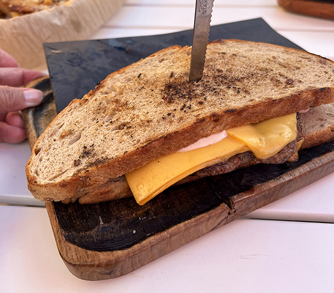 The Patty Melt: where burger meets sandwich in a melty cheese liaison. This grilled masterpiece proves that sometimes the best relationships happen between two slices of toasted bread.