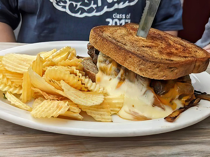 Behold the patty melt&mdash;where melted cheese cascades like a dairy waterfall over caramelized onions and beef. Paired with ripple chips, it's comfort on a plate.