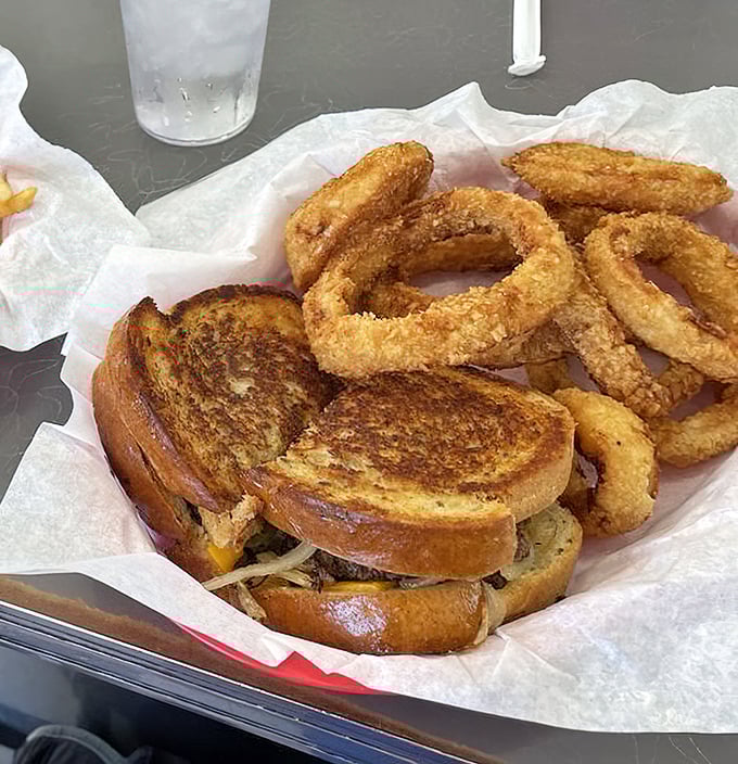 Grilled cheese perfection meets golden onion rings &ndash; a combo that would make both your cardiologist and inner child have strong opinions.