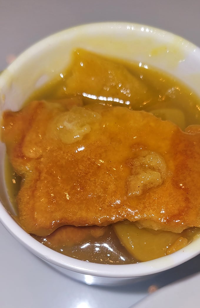 This isn't just peach cobbler – it's Southern comfort in a bowl, waiting to transport you to a front porch somewhere in Tennessee's sweetest memories.