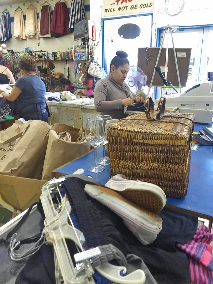 The sorting station: retail archaeology in action as treasures are examined, priced, and given their second chance at usefulness.