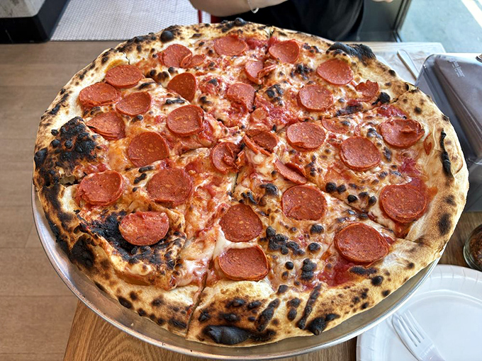 The pepperoni curls into little flavor cups, collecting precious oils like tiny edible chalices. This is pizza engineering at its finest.