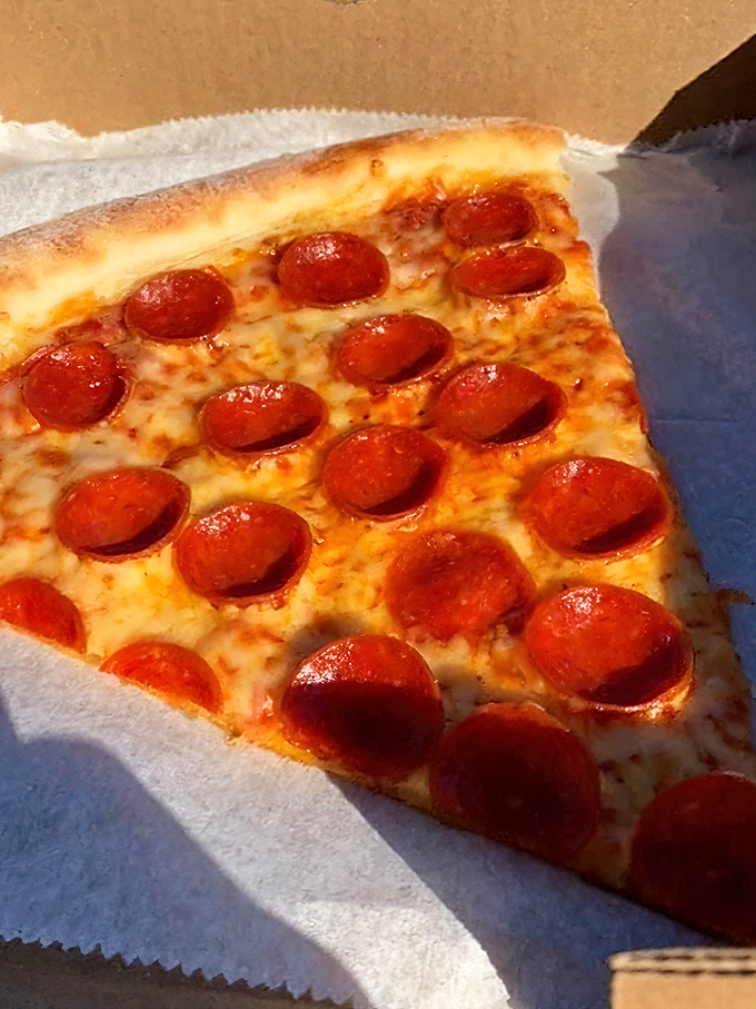 A perfect pepperoni slice that makes New Yorkers question their loyalty. The curl of those pepperoni cups holding tiny pools of savory oil is pizza perfection.