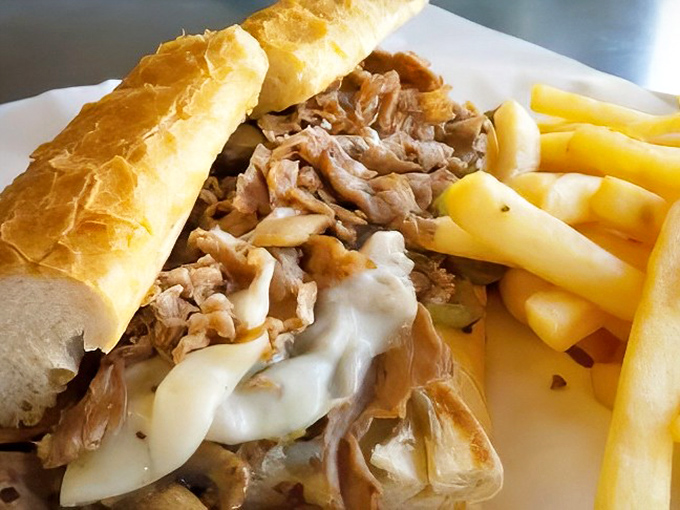 A proper Philly cheesesteak should require both napkins and commitment. This one, overflowing with tender meat and melted cheese, demands both in the best possible way.