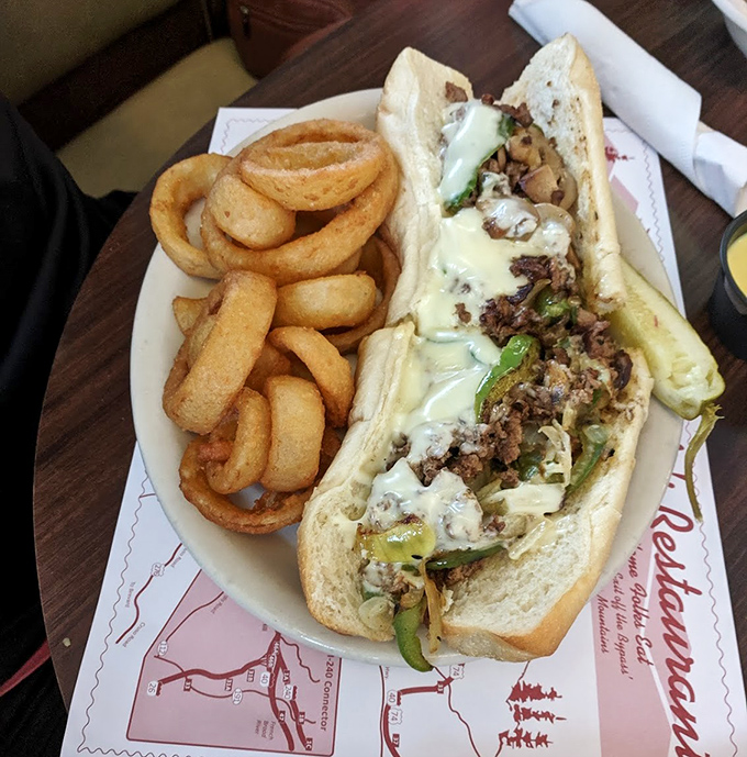 This isn't just a Philly cheesesteak&mdash;it's a masterclass in sandwich architecture, with perfectly melted cheese cascading over seasoned beef. Those onion rings deserve their own zip code.